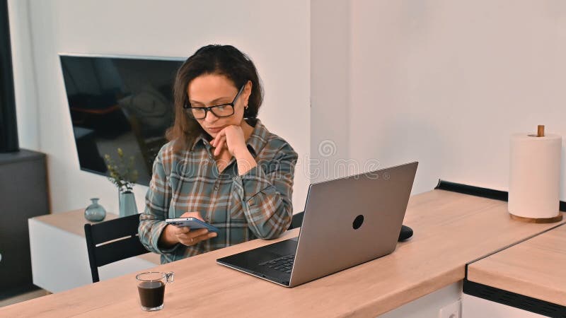 Woman Working Remotely Using Laptop and Smartphone in Cozy Modern Home ...