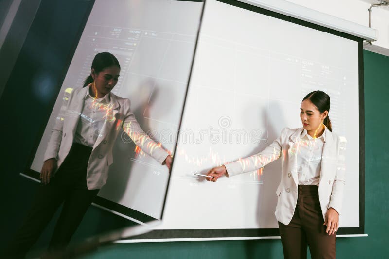 A Professional Woman Presents Information in Front of a Projector ...