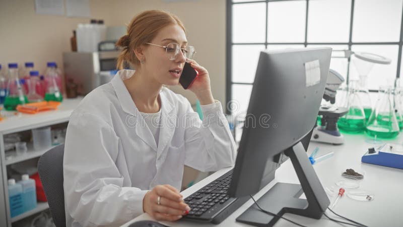A Professional Woman Scientist in a Lab Coat Converses on the Phone ...