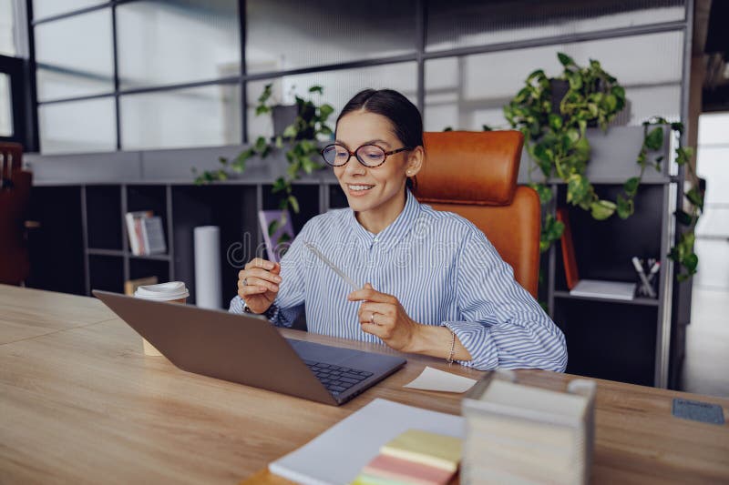 A Professional Woman is Successfully Working Remotely in a Stylish ...