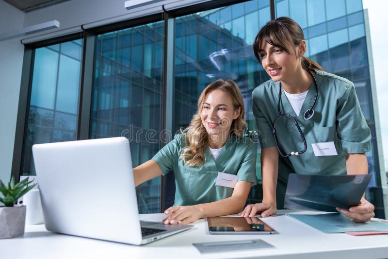 Professional Women Doctors Examining Patient S X-ray Working Together ...