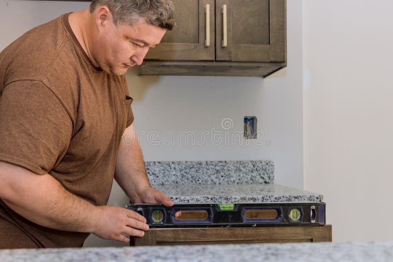 Professional Worker Assembling Leveling Countertop for Cabinet Stock ...