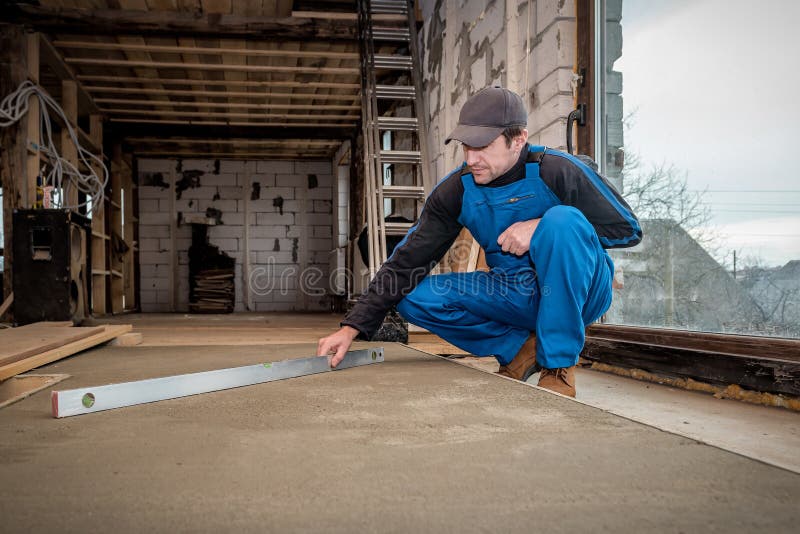 Worker with Level Tool Measures Concrete Floor Stock Photo - Image of ...