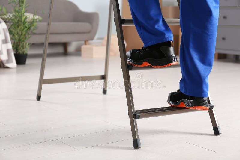 Professional Worker Climbing Up Ladder in Room, Closeup Stock Photo ...