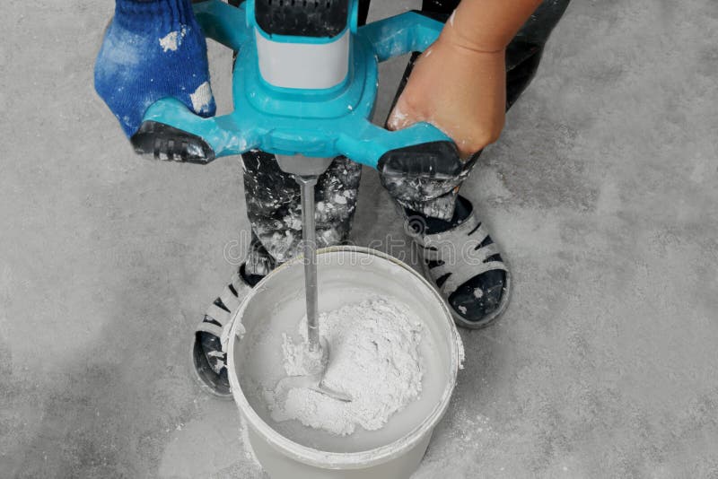 Professional Worker Mixing Plaster in Bucket Indoors, Closeup Stock ...