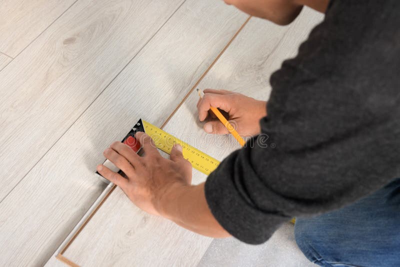 Professional Worker Using Ruler during Installation of Laminate ...