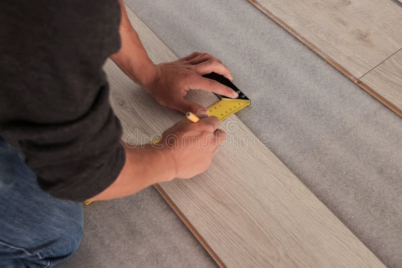 Professional Worker Using Ruler during Installation of Laminate ...