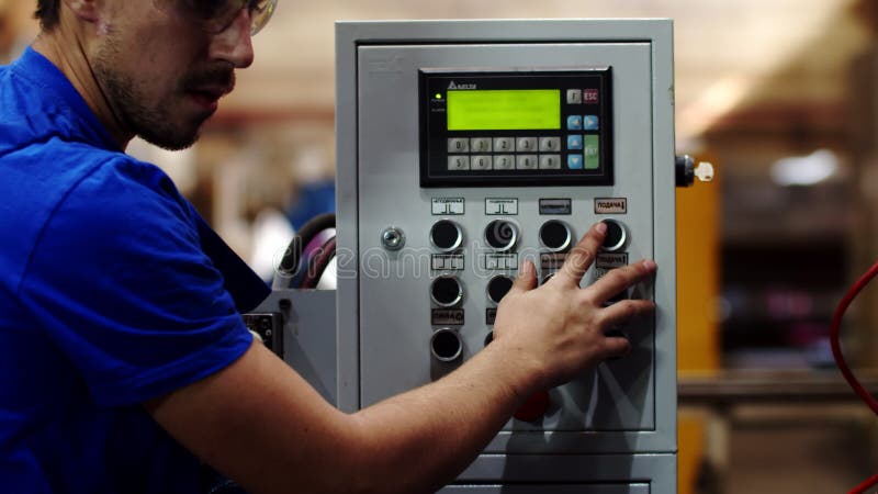 Professional Worker Watching Over Manufacturing Process on an Indoor ...