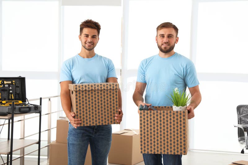 Professional Workers with Cardboard Boxes. Moving Service Stock Photo ...