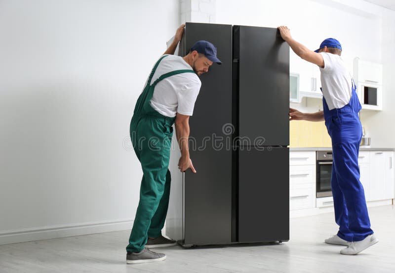 Professional Workers Carrying Refrigerator In Kitchen Stock Image ...