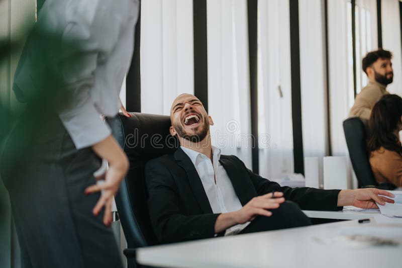 Colleagues Laughing Together in a Collaborative Business Office Setting ...
