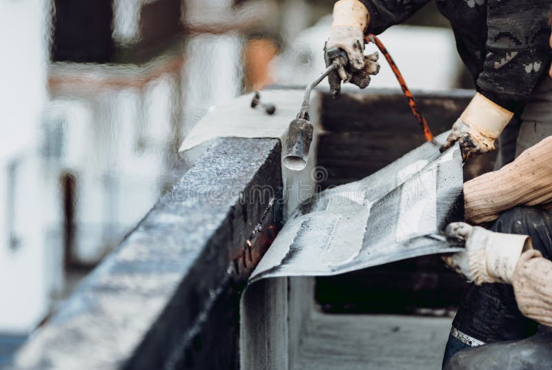 Workers Waterproofing Flat Concrete Roof Using Blowtorch and Bituminous ...