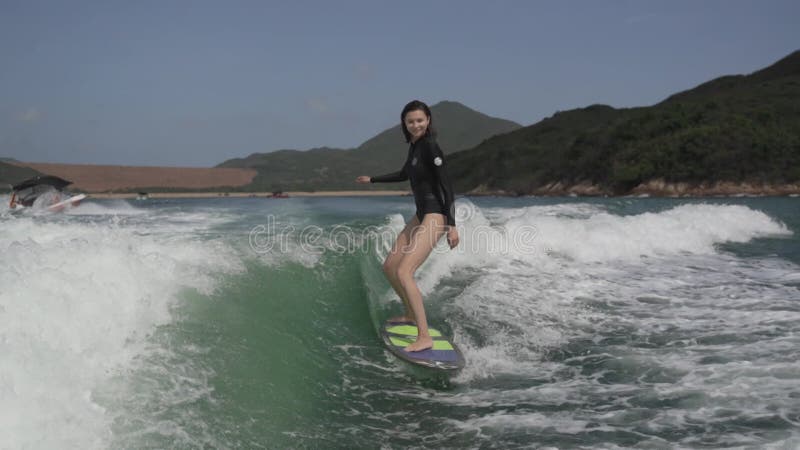Professional Young Female Surfer Dancing on Her Board while Riding a ...