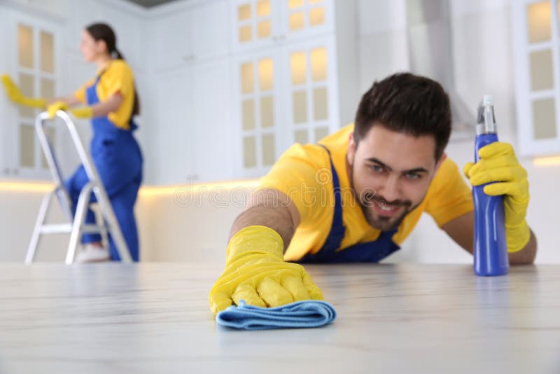 Professional Young Janitor Cleaning Table Stock Photo - Image of ...