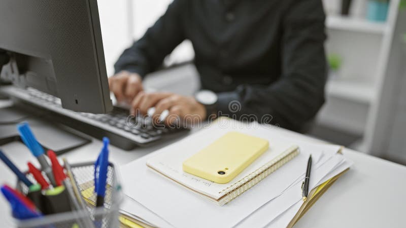 A Professional Young Man Works on a Computer in a Modern Office Setting ...