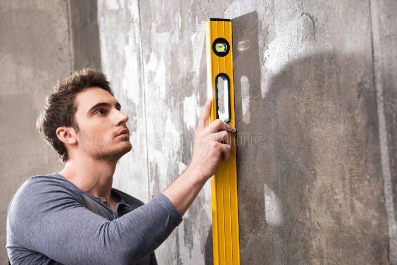 Professional Young Worker Measuring Wall with Level Tool Stock Image ...