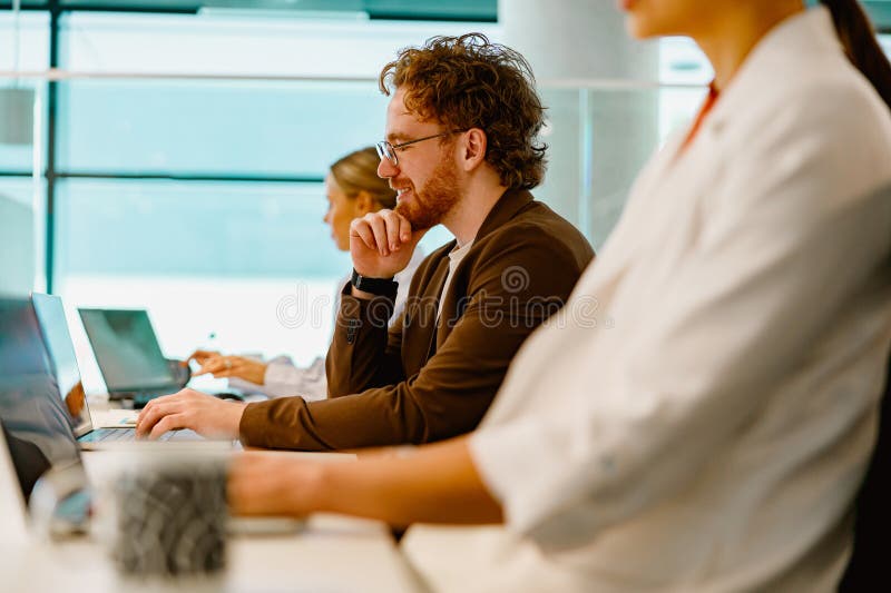 Dedicated and Focused Professionals Engaged in Work on Laptops in a ...