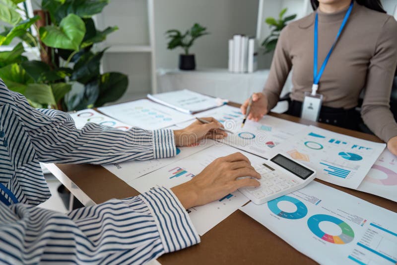 Collaborative Business Meeting with Charts and Calculator in a Modern ...