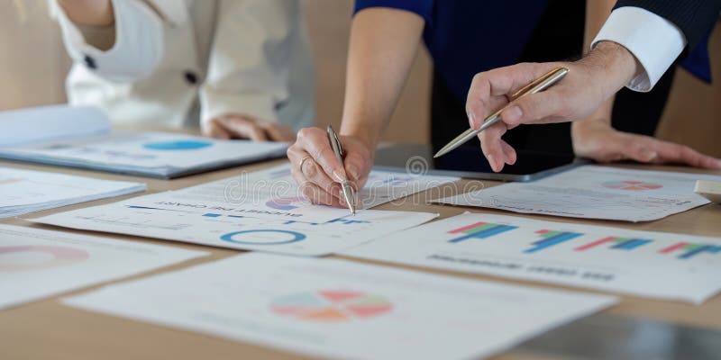 Team Collaborating on Financial Reports and Charts in a Modern Office ...