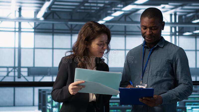 It Professionals in Data Center Reviewing Reports and Files Stock Photo ...