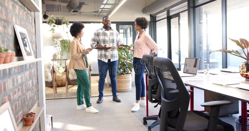 Professionals Discussing Teamwork in a Modern, Diverse Office Setting ...