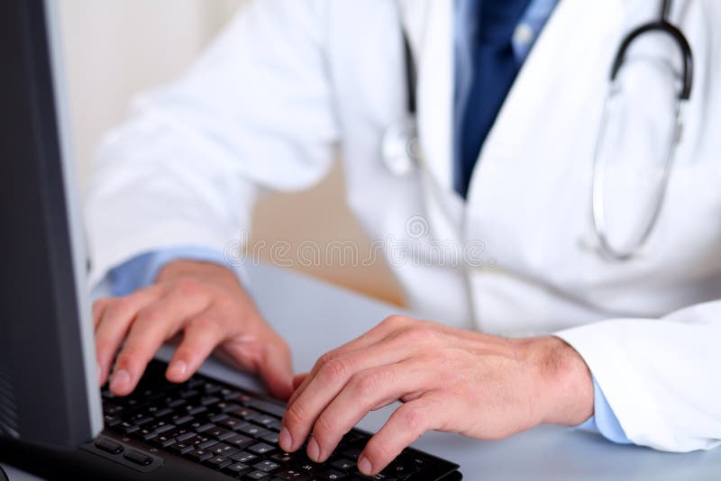 Doctor Working with Laptop Computer in Medical Workspace Office. Focus ...