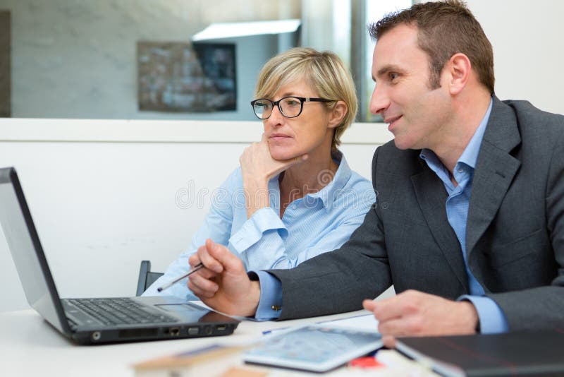 Professionals Looking at Data Presented in Laptop Stock Photo - Image ...