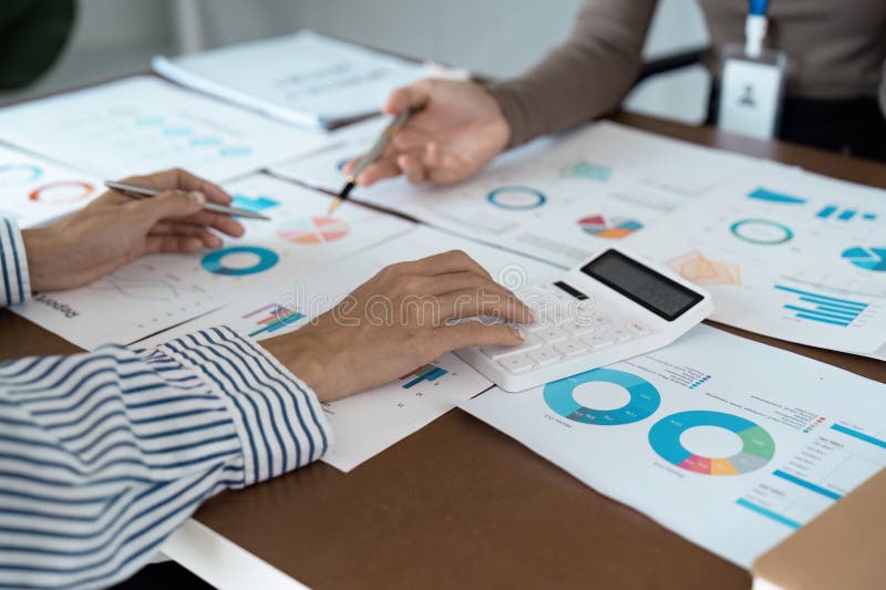Business Team Analyzing Financial Data with Charts and Calculator in a ...