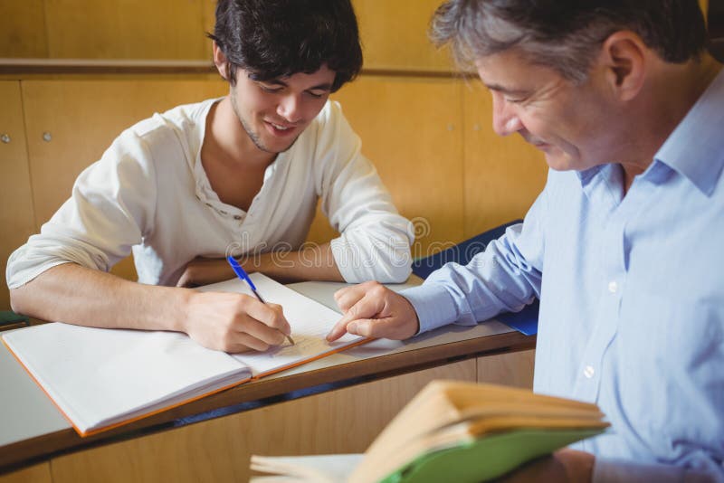 Professor Assisting a Student with Studies Stock Image - Image of ...