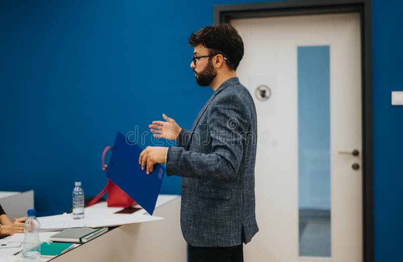 Professor Assisting Students during Class with Assignments Stock Photo ...