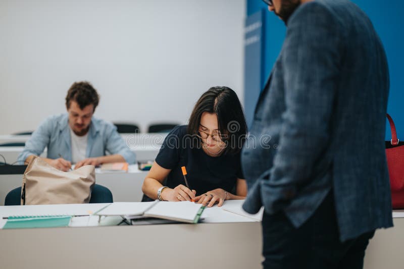 Professor Assisting Students during an Engaging Classroom Session Stock ...