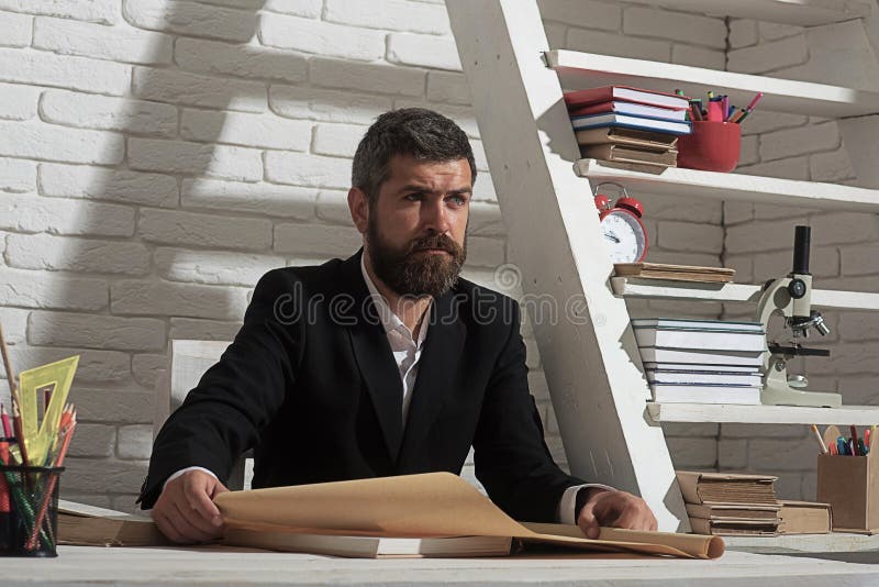 Professor with Confident Face Expression Sits at Desk Stock Image ...