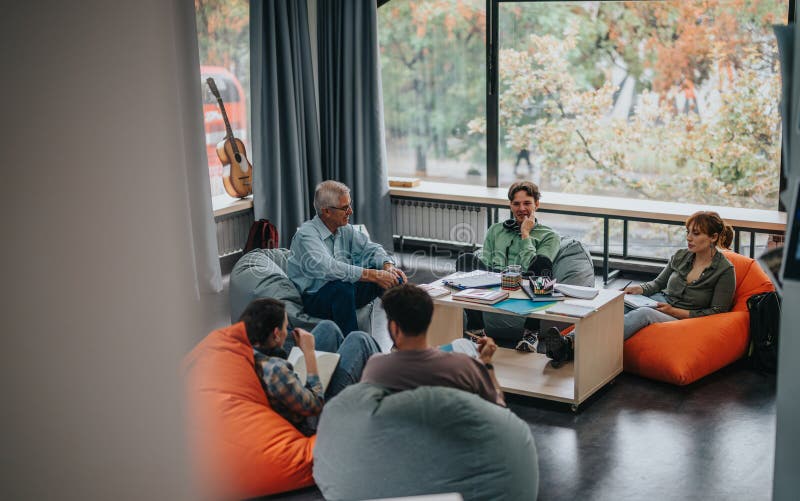 Professor Engaging with Students in a Casual Learning Environment Stock ...