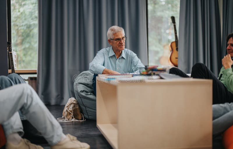 Professor Engaging with Students in a Relaxed Classroom Setting Stock ...