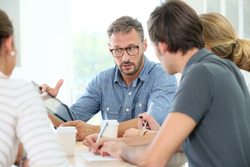 Professor Explaining Subject To Students with Tablet Stock Photo ...