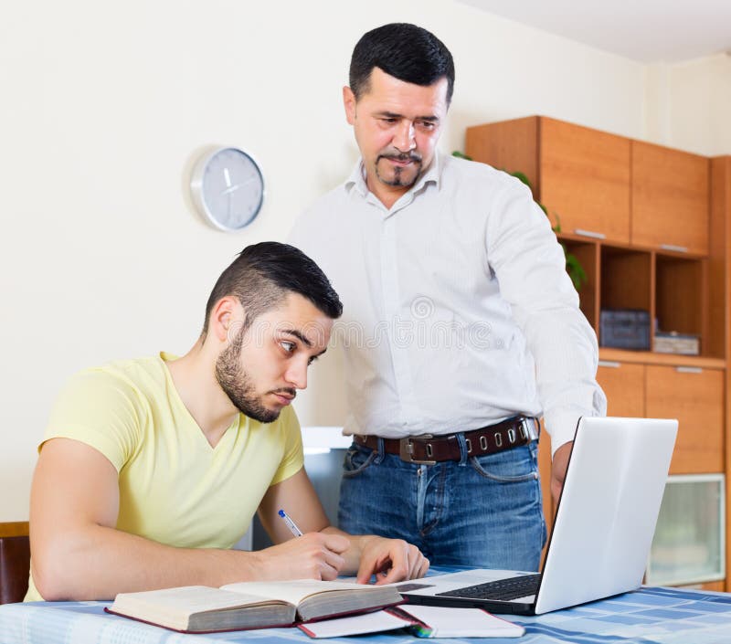 Professor Giving Lesson To Student Stock Photo - Image of friends, desk ...