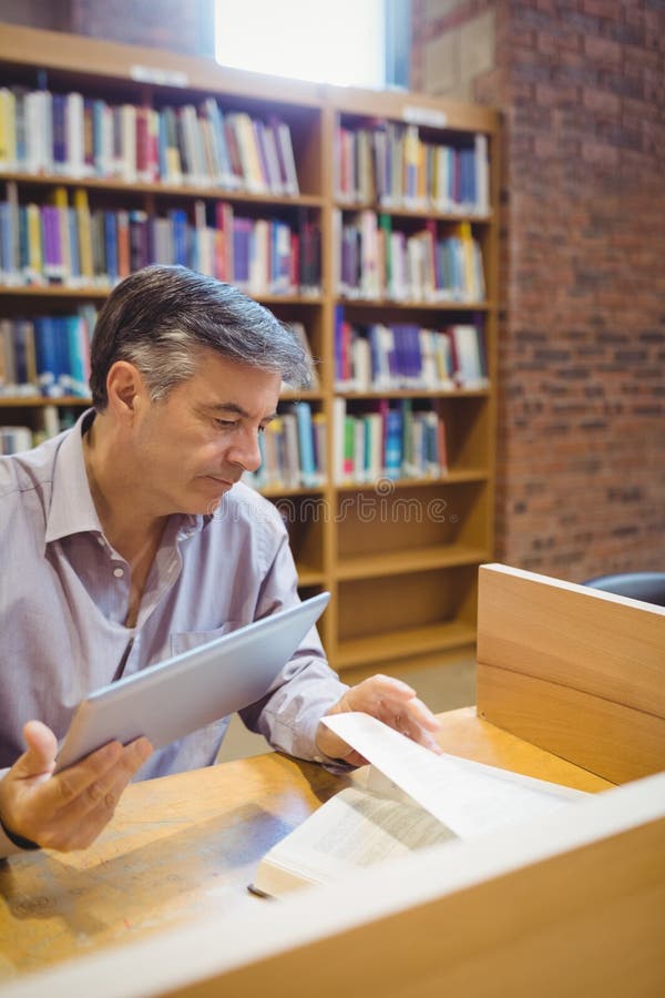 Professor Holding Digital Tablet and Reading Book Stock Image - Image ...