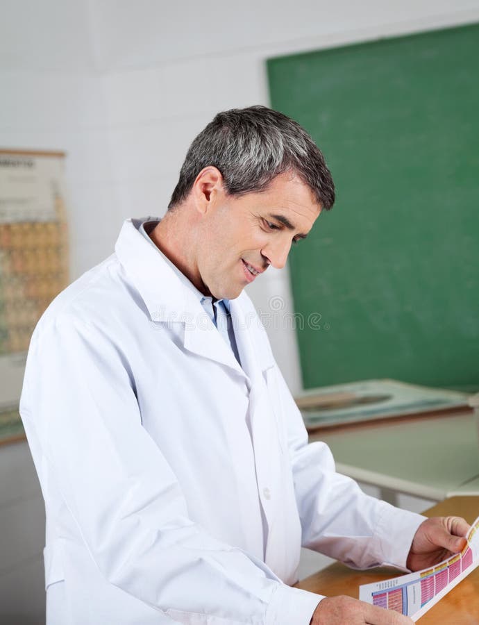 Professor Reading Paper at Desk in Lab Stock Photo - Image of knowledge ...