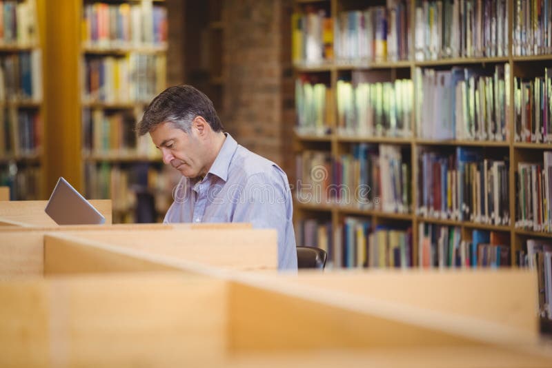 Professor Sitting at Desk Using His Laptop Stock Image - Image of ...