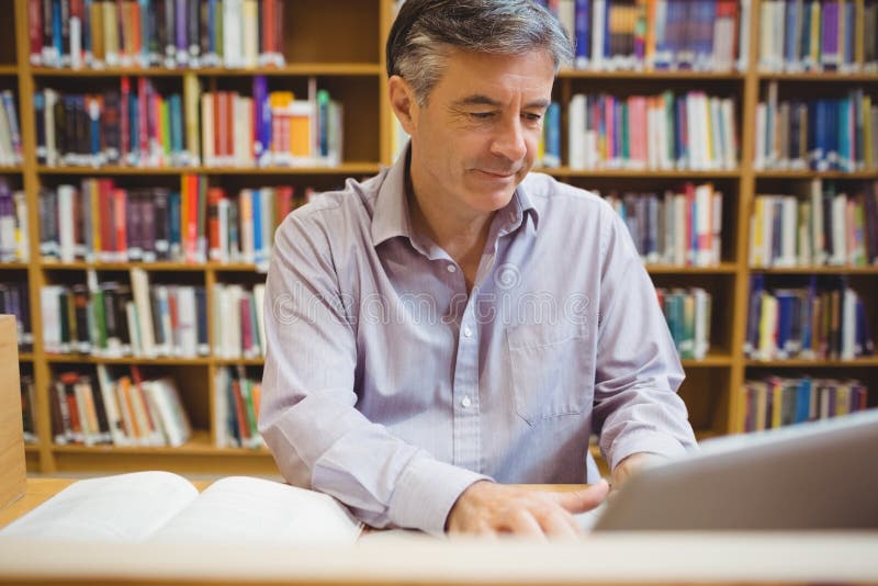 Professor Sitting at Desk Using Digital Tablet Stock Image - Image of ...