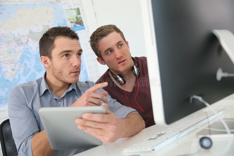 Professor with Student Working on Desktop Computer Stock Photo - Image ...