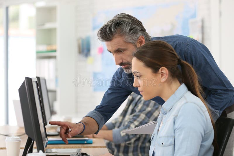 Professor with Student Working on Desktop Computer Stock Photo - Image ...