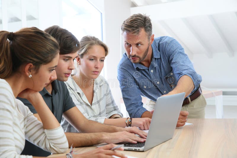 Professor and Students Working on Laptop Stock Photo - Image of class ...