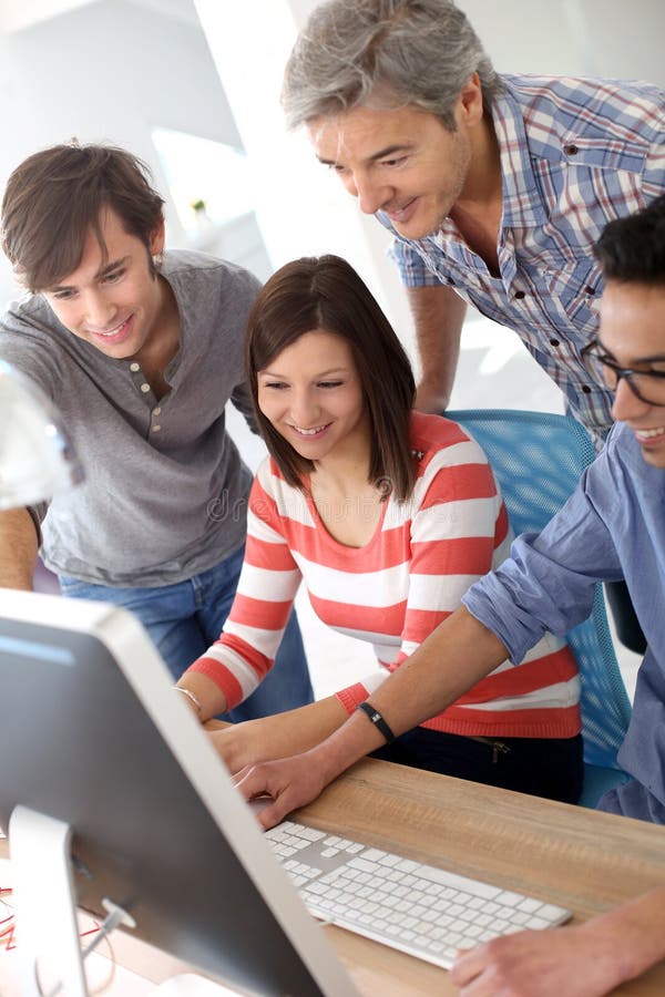 Professor with Students Working Together Stock Photo - Image of project ...