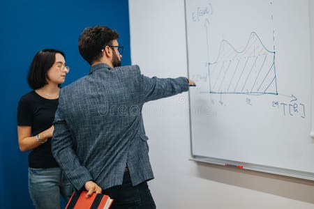 Professor Teaching Students with Charts on Whiteboard Stock Image ...