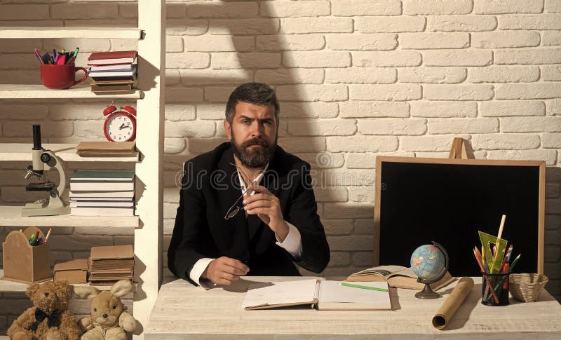 Professor with Thoughtful Face Expression Sits at Desk Stock Image ...