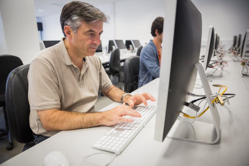 Professor Sitting at Desk Using Digital Tablet Stock Image - Image of ...