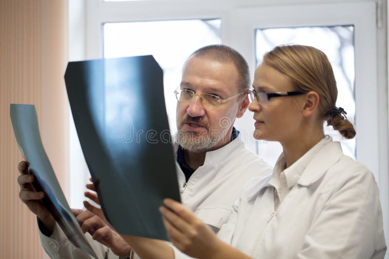 Professor and Young Doctor Comparing X-rays Stock Photo - Image of ...