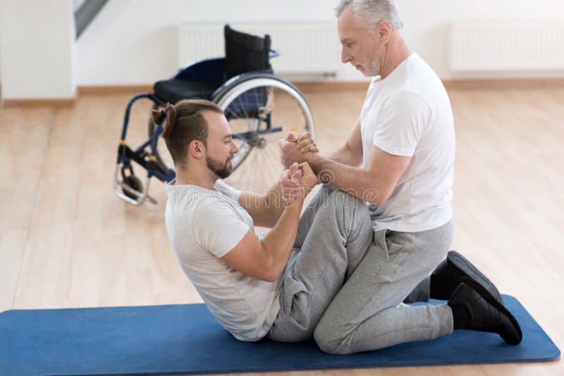 Proficient General Practitioner Stretching Disabled Gym Stock Photos ...