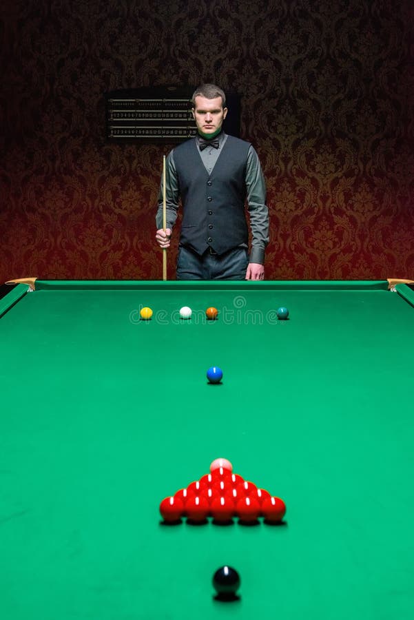 A Proficient Male Snooker Player Demonstrates Precision and Focus on ...